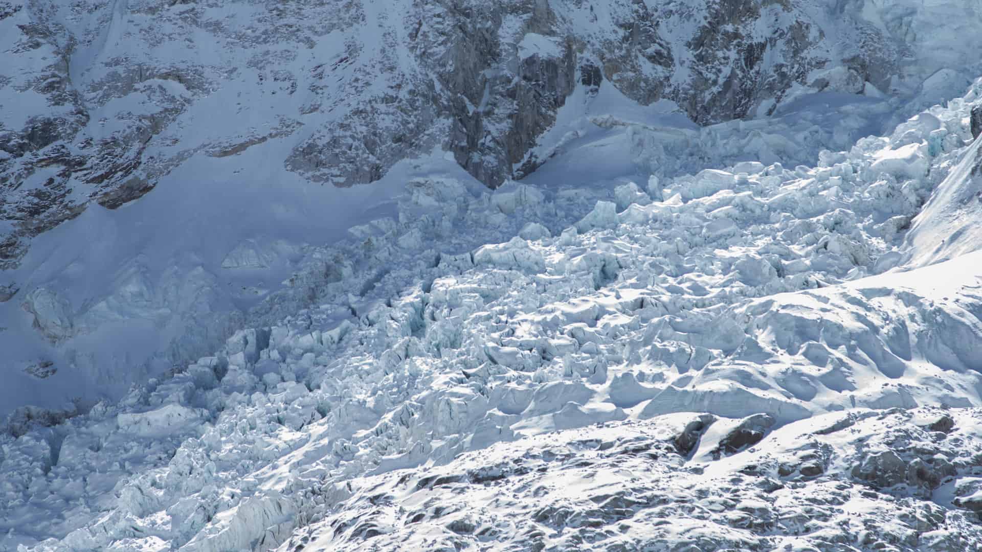 First light and shadow reveal with climbers of the Khumbu Icefall ...