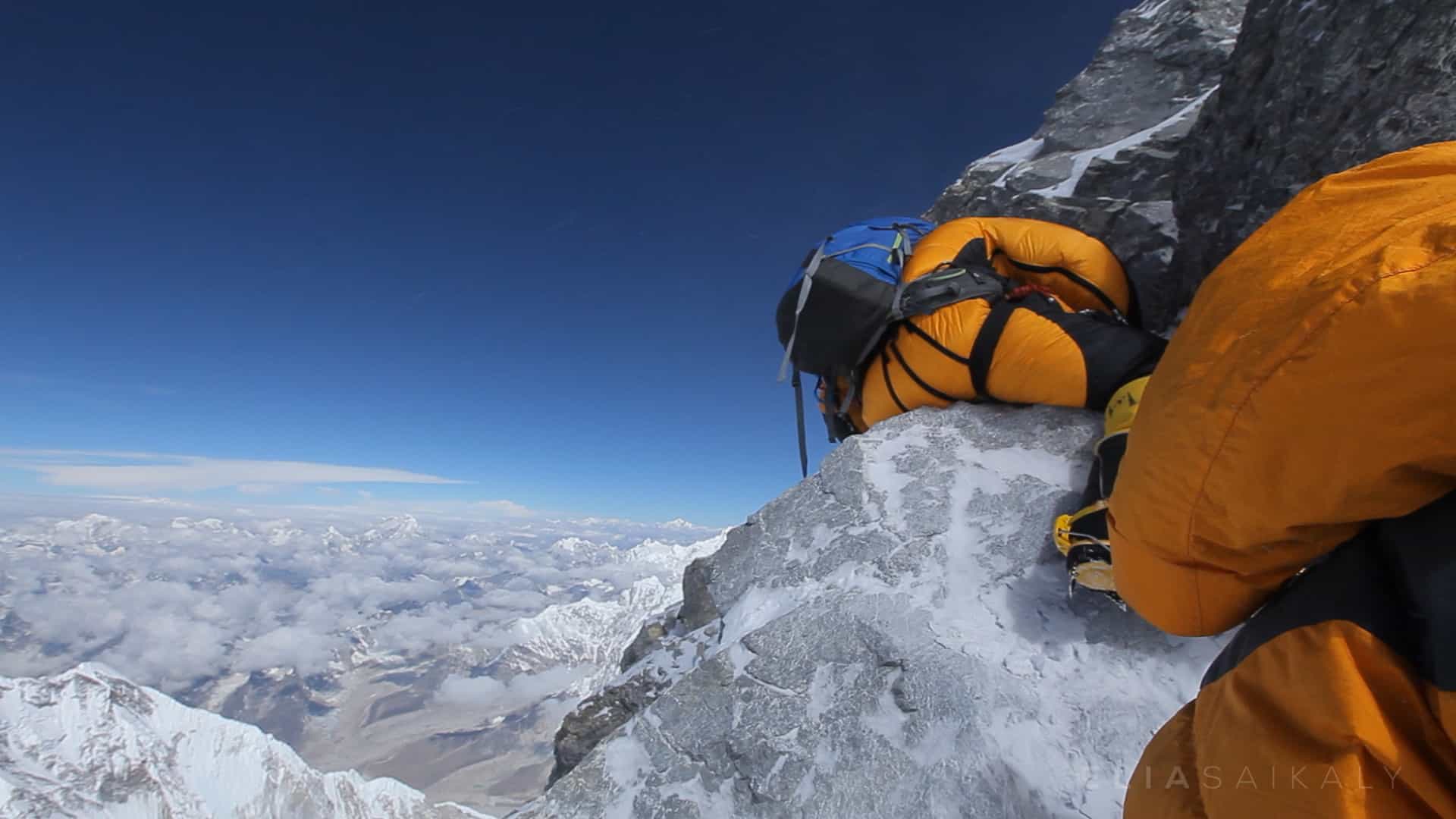 Straddling the rock above the Hillary Step - Elia Saikaly Licensing