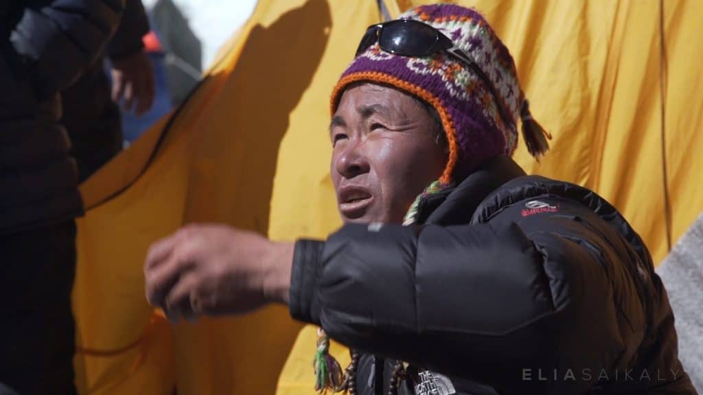 Close up of Sherpa tossing rice in the air during a Puja ceremony at ...