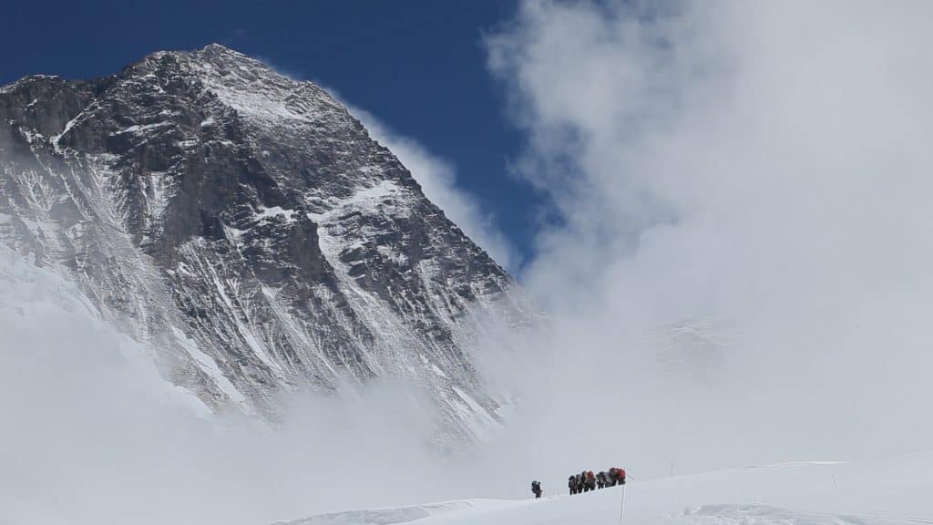Epic shot of Everest with climber and clouds while approaching camp 2 ...